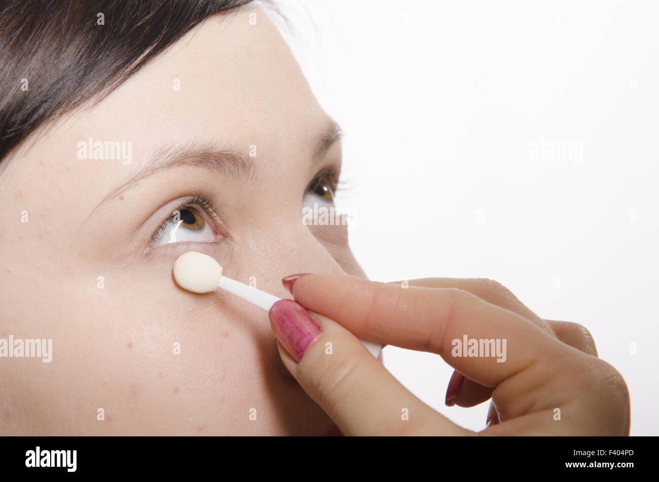 Makeup artist colors upper eyelids model Stock Photo - Alamy