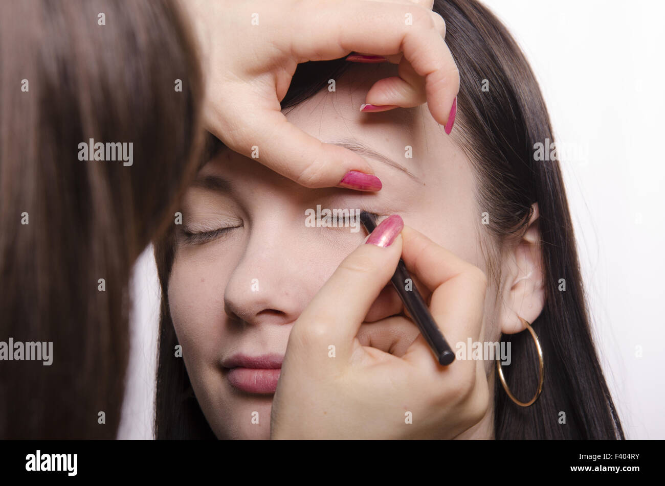 Makeup artist colors eyelashes model Stock Photo - Alamy