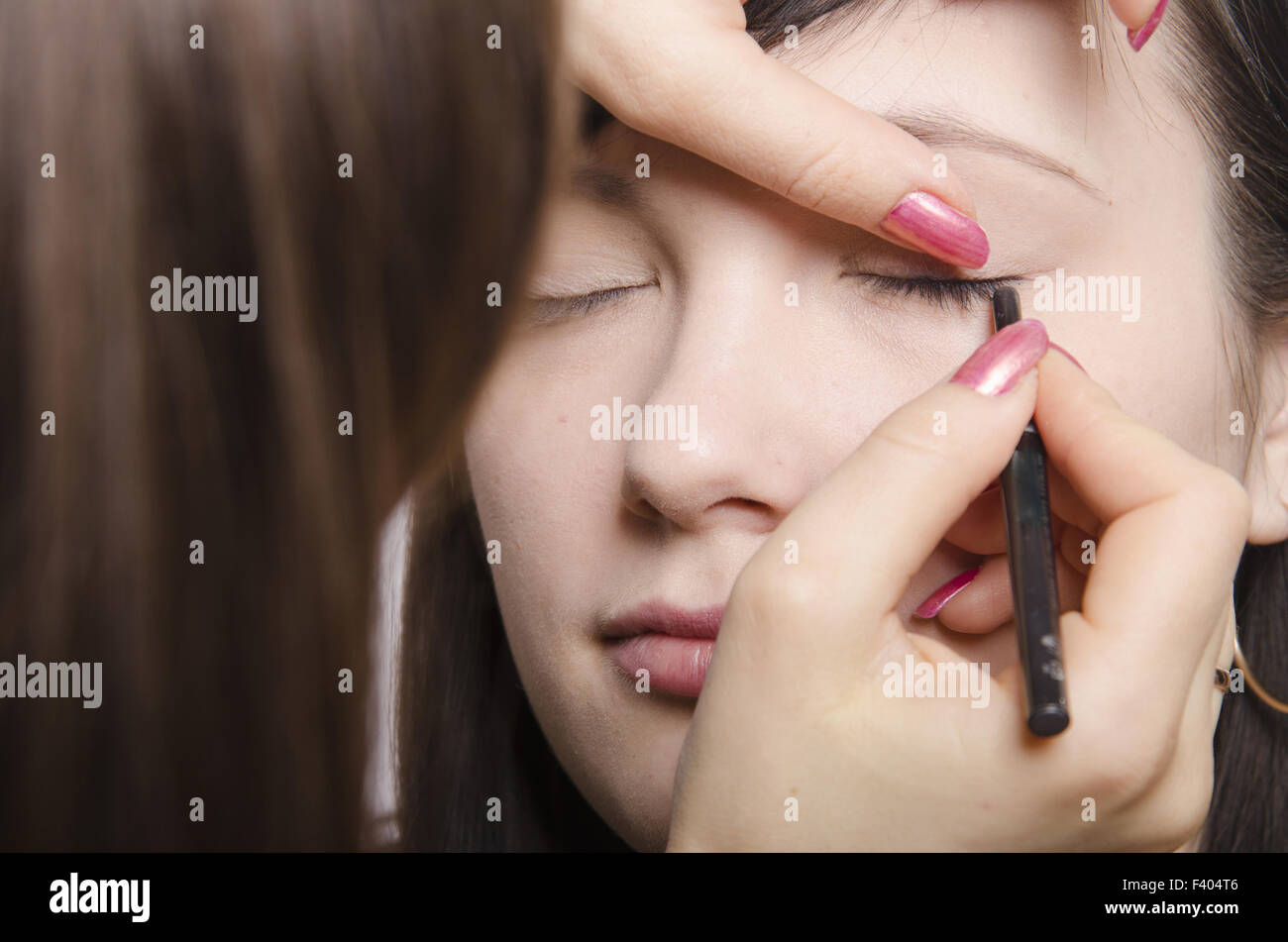 Makeup artist colors eyelashes model Stock Photo - Alamy