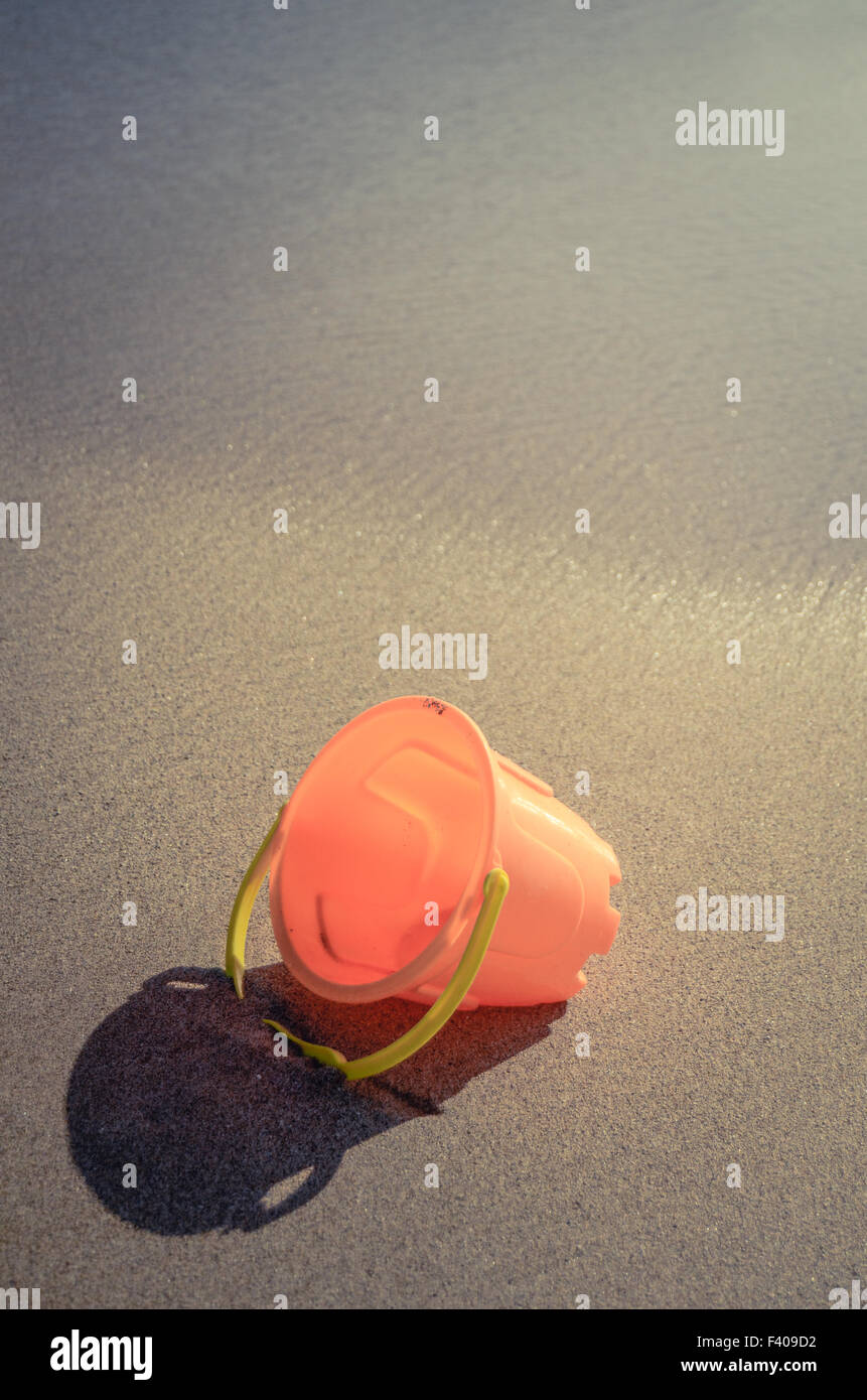 Bucket In Wet Sand Stock Photo - Alamy