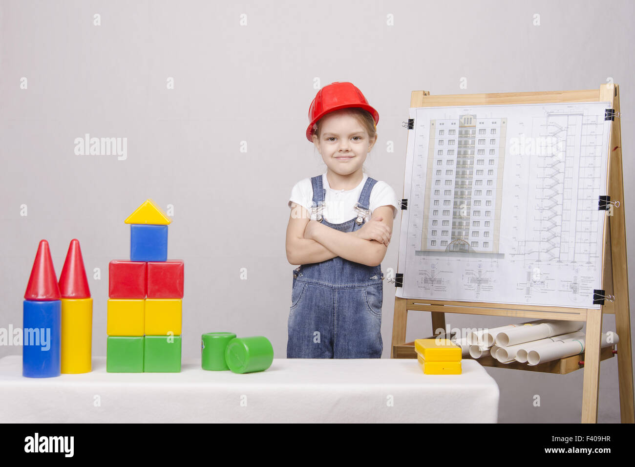 Child Builder builds a house on the drawing Stock Photo - Alamy