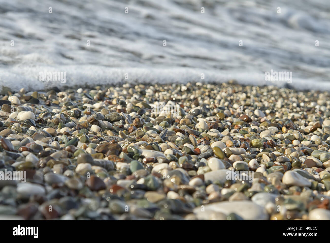 Small pebbles and waves Stock Photo - Alamy