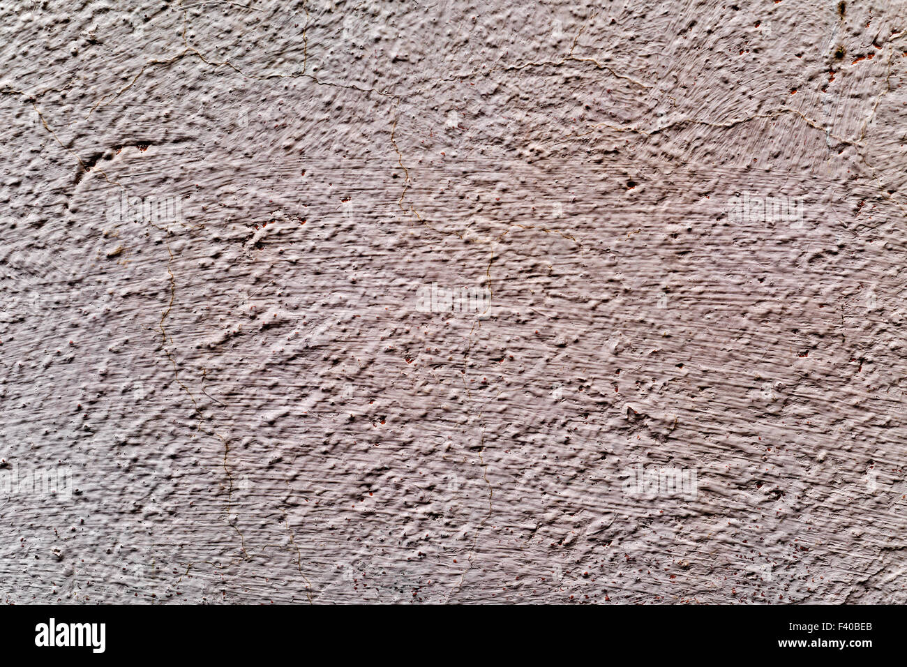 closeup of a rustic beige plastered wall to be used as a texture or a ...