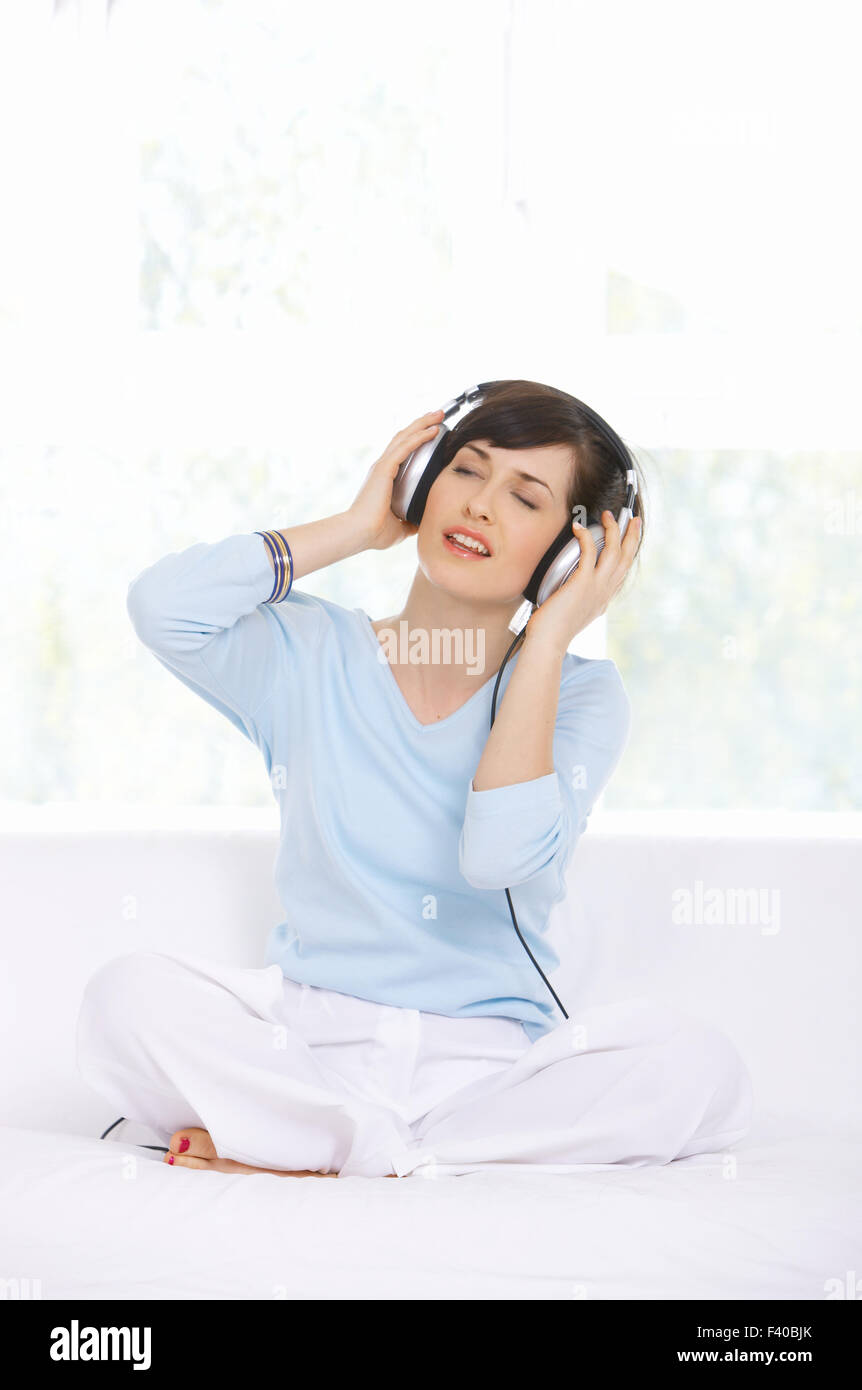 Sitting Woman Listening Music Through Headphone Stock Photo - Alamy