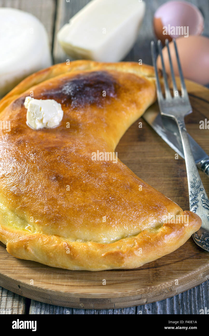 Cheese pie with a slice of butter Stock Photo - Alamy
