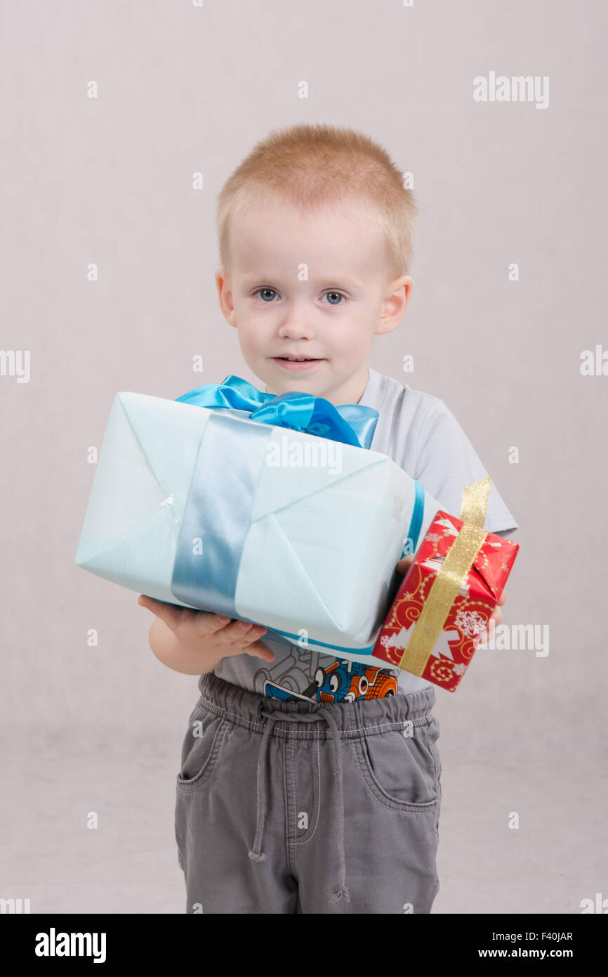 boy stands with two gifts Stock Photo - Alamy