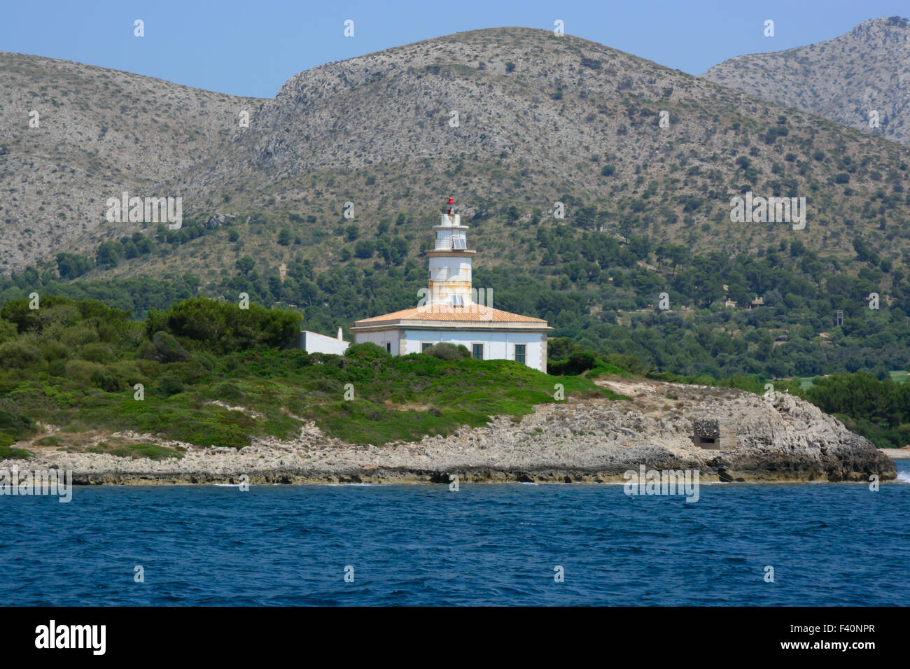 Alcanada lighthouse from the sea. Mallorca Stock Photo - Alamy