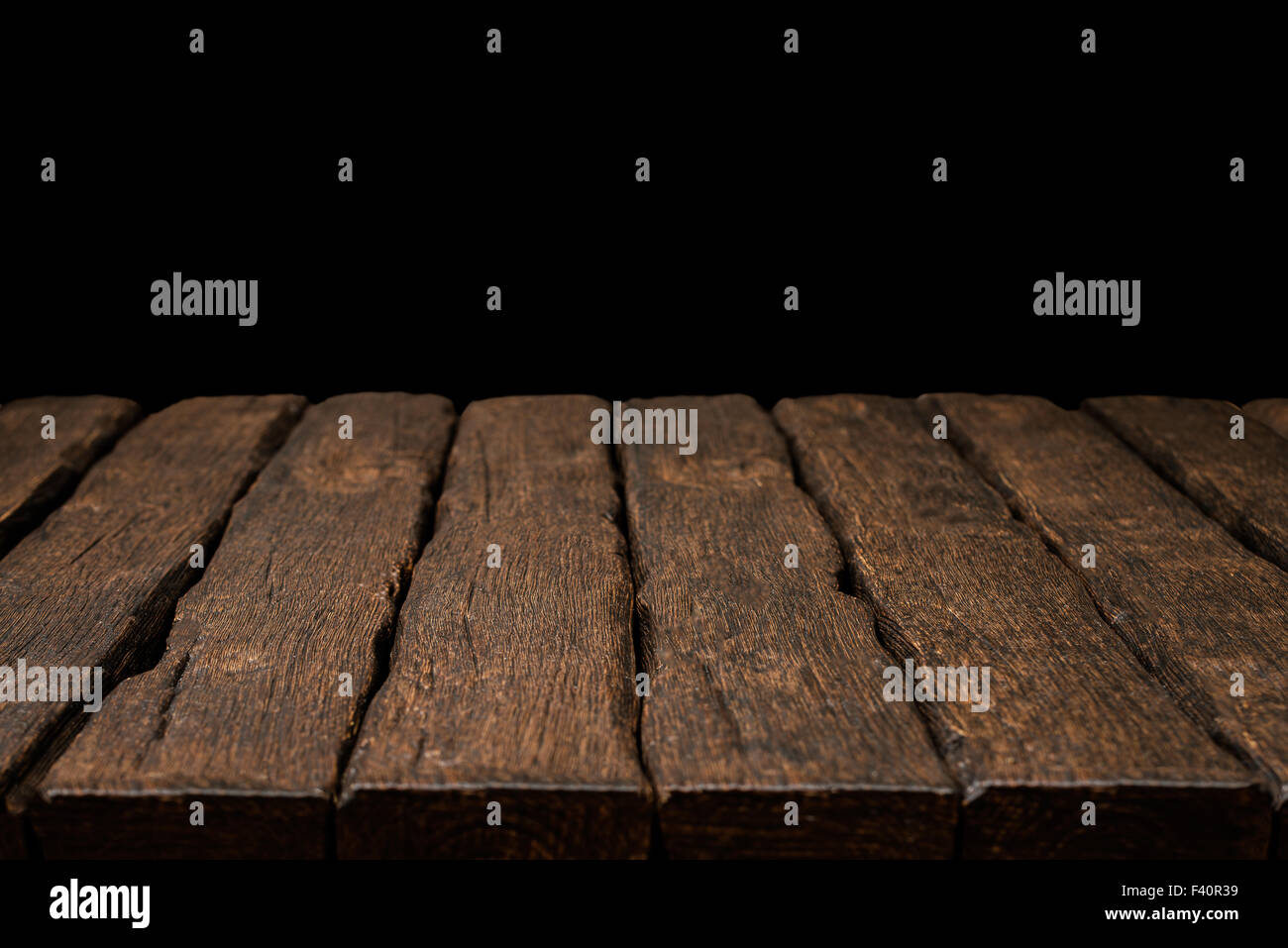 Old rustic wooden table top with solid black background Stock Photo - Alamy
