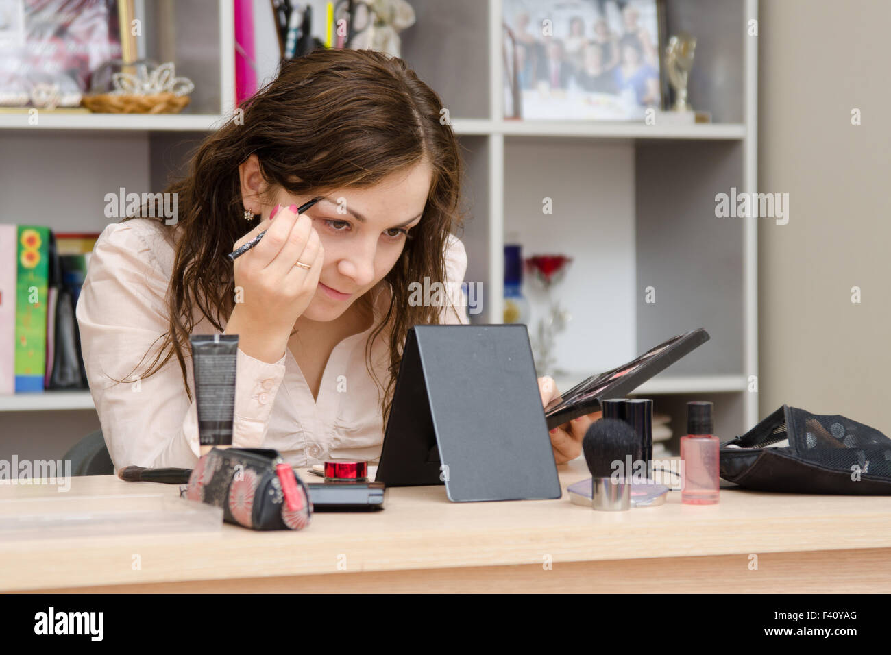 Office worker paints the eyebrows Stock Photo - Alamy
