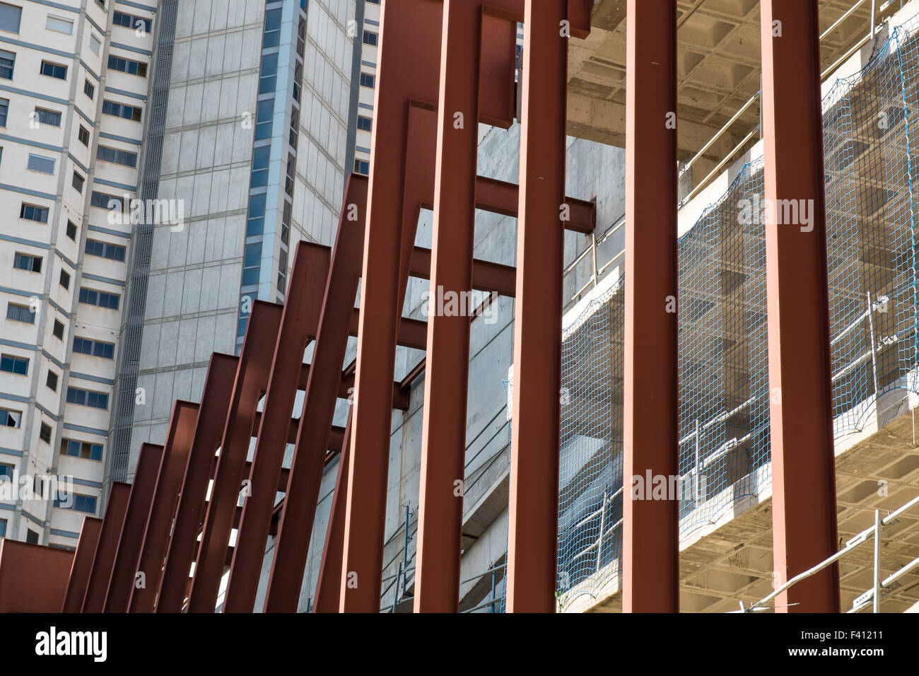 Girder of an unfinished high rise building with a finished tower in the ...