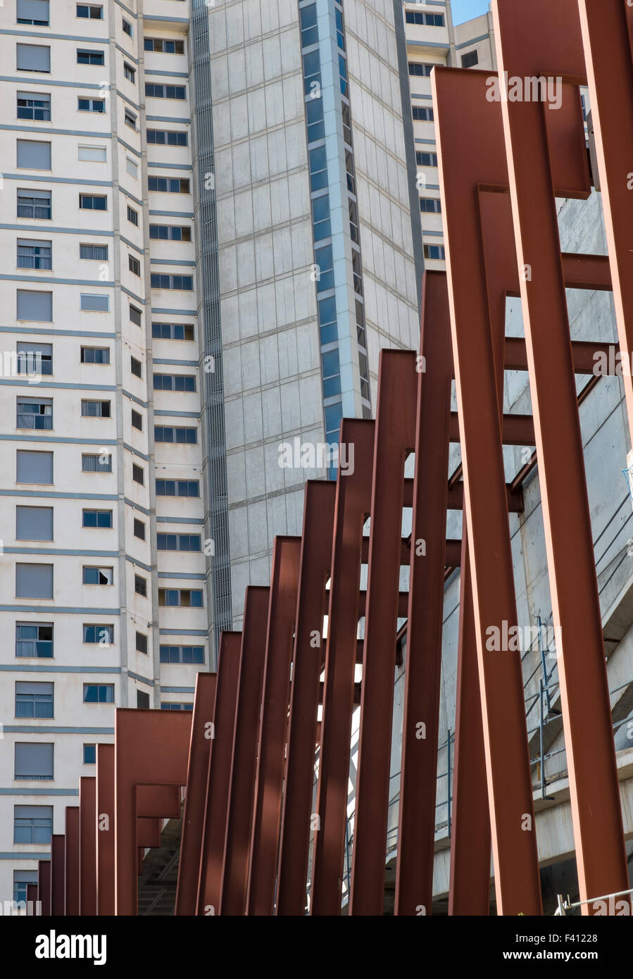 Girder of an unfinished high rise building with a finished tower in the ...