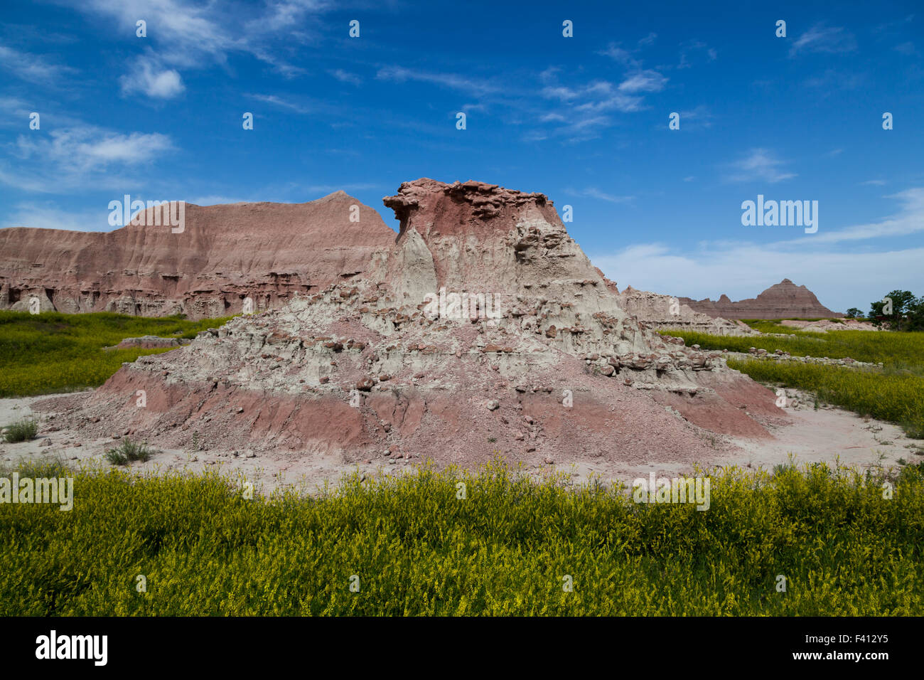 A mound of rock and clay layers eroding to create a new formation and ...