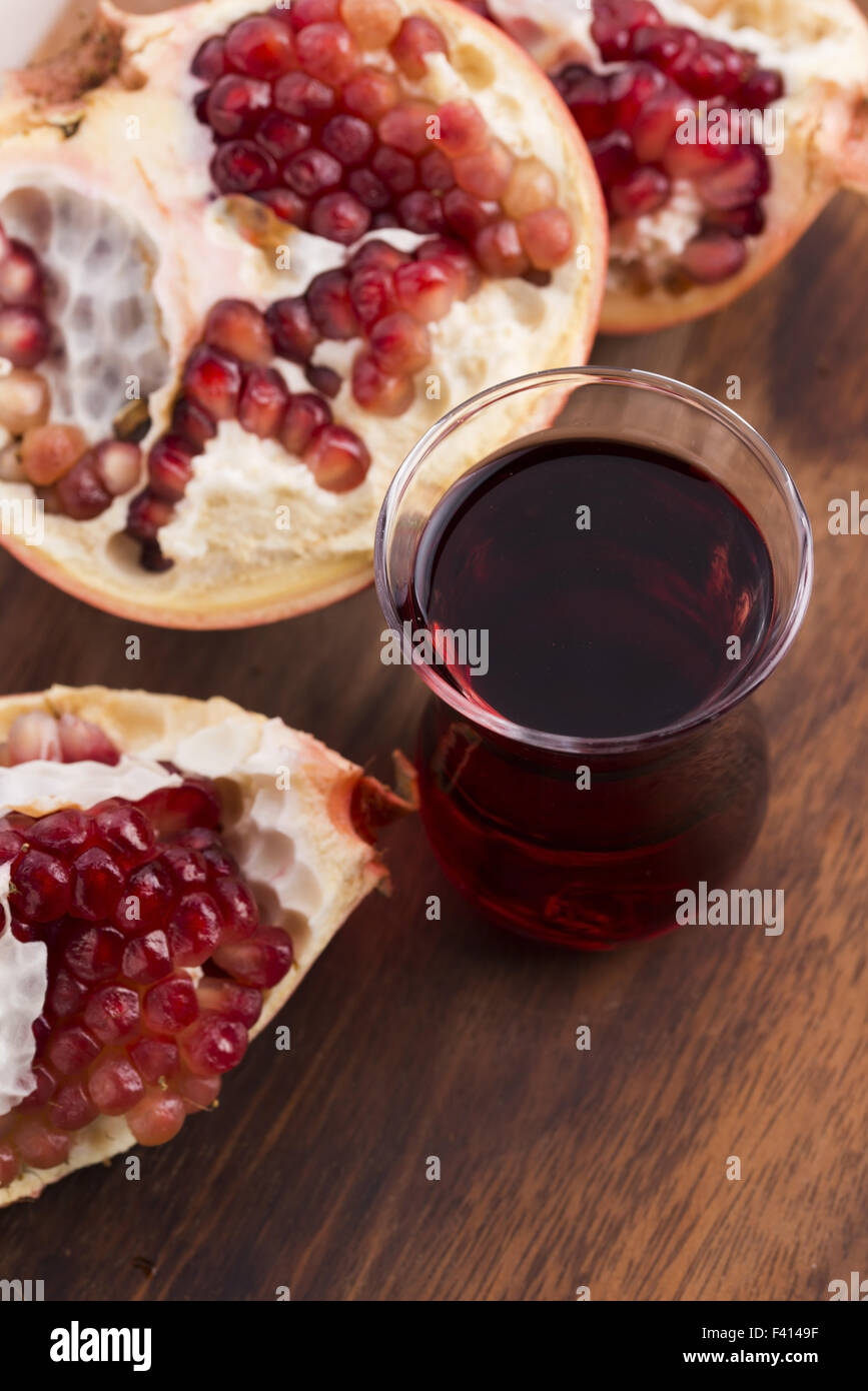 Ripe pomegranates with juice on table Stock Photo - Alamy