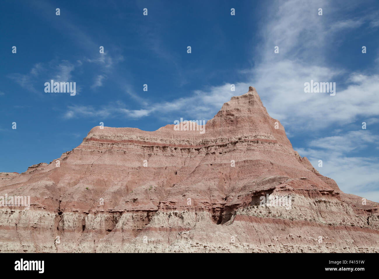 Layers of clay and rock carved out by erosion creating a dramatic peak ...