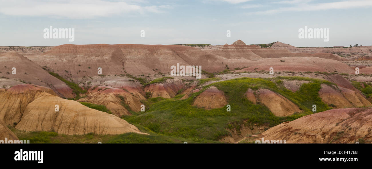 The colorful mounds of rock and clay in Badlands National Park covered ...