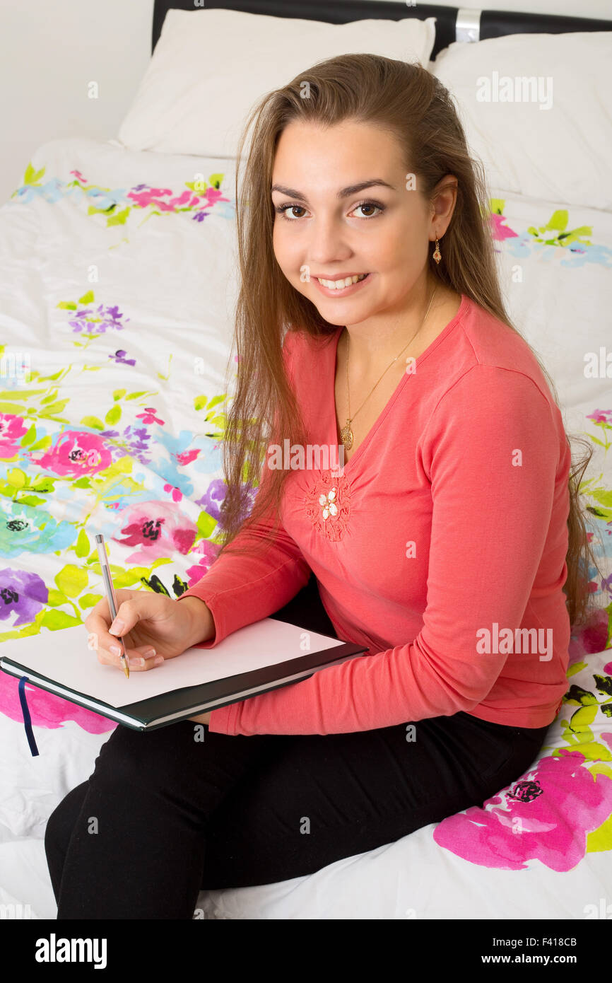 young woman writing a letter in her bedroom Stock Photo - Alamy