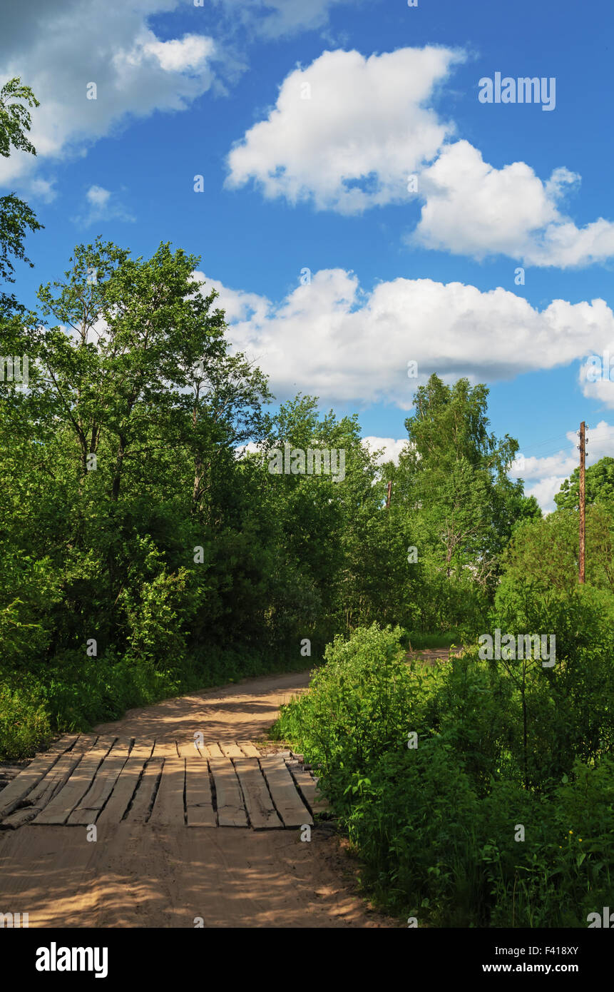 Village landscape with wooden bridge Stock Photo - Alamy
