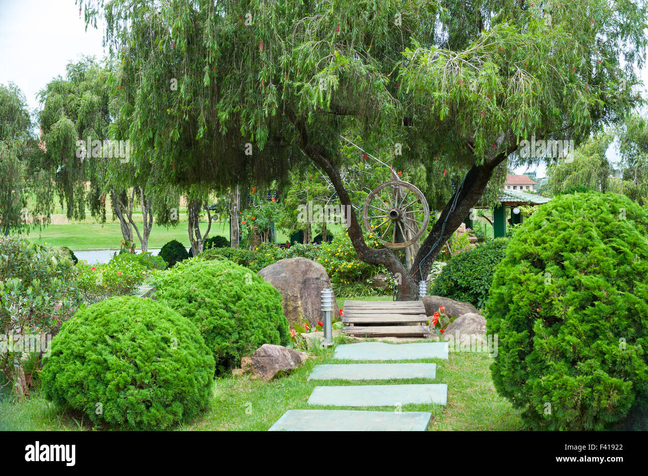 branchy park tree with wagon wheel Stock Photo - Alamy