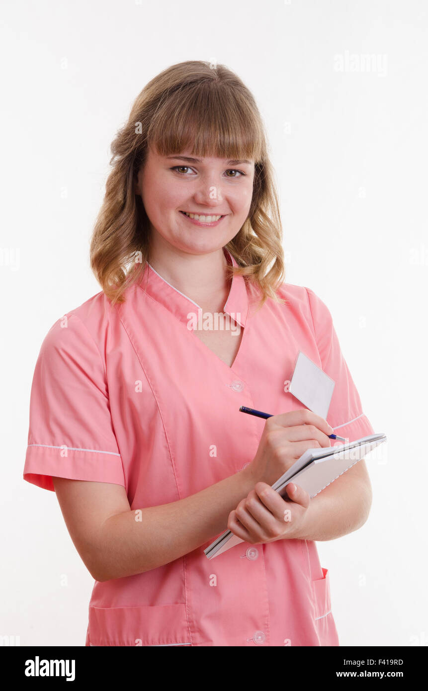 Doctor writing in a notebook Stock Photo - Alamy