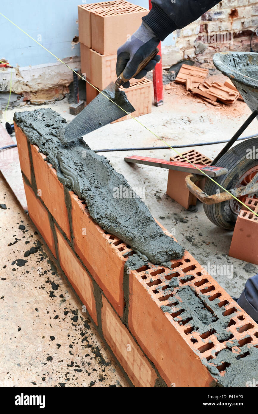 Hand laying brick hi-res stock photography and images - Alamy