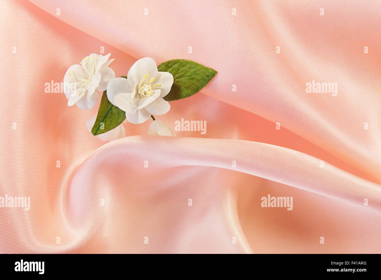 Jasmine on pink fabric Stock Photo - Alamy