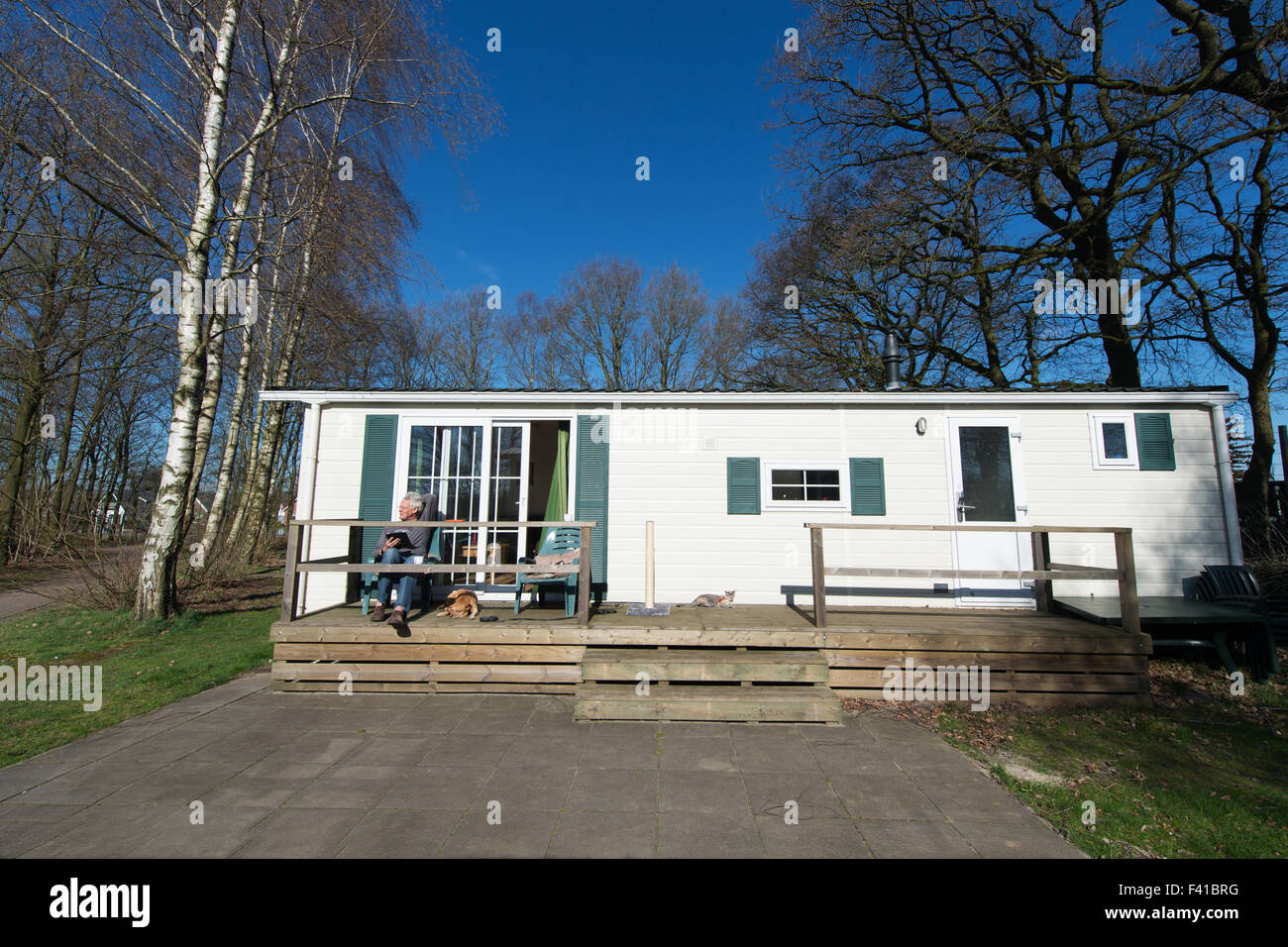Senior man sitting outdoor by mobile home Stock Photo - Alamy