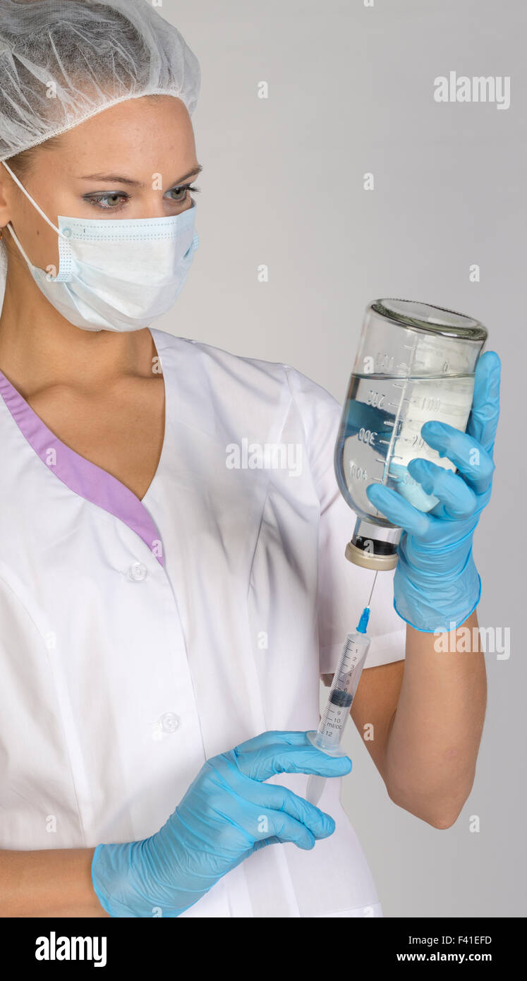 Female doctor picking up the syringe injection Stock Photo - Alamy