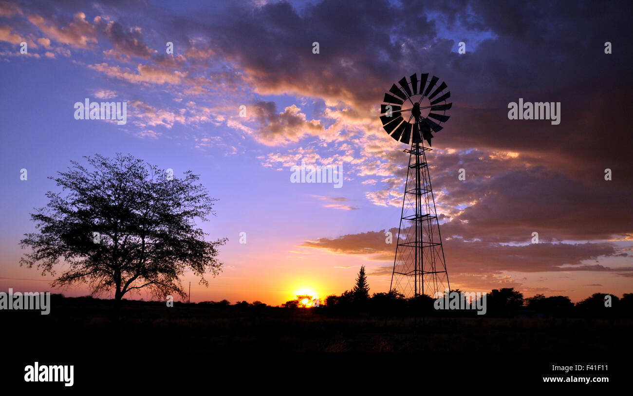 Windmill in desert sunset Stock Photo - Alamy