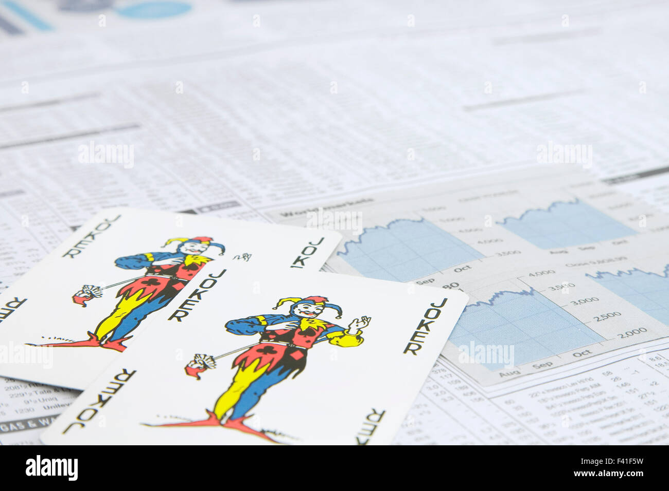 Playing cards showing Two Jokers on a News paper Stock market financial ...