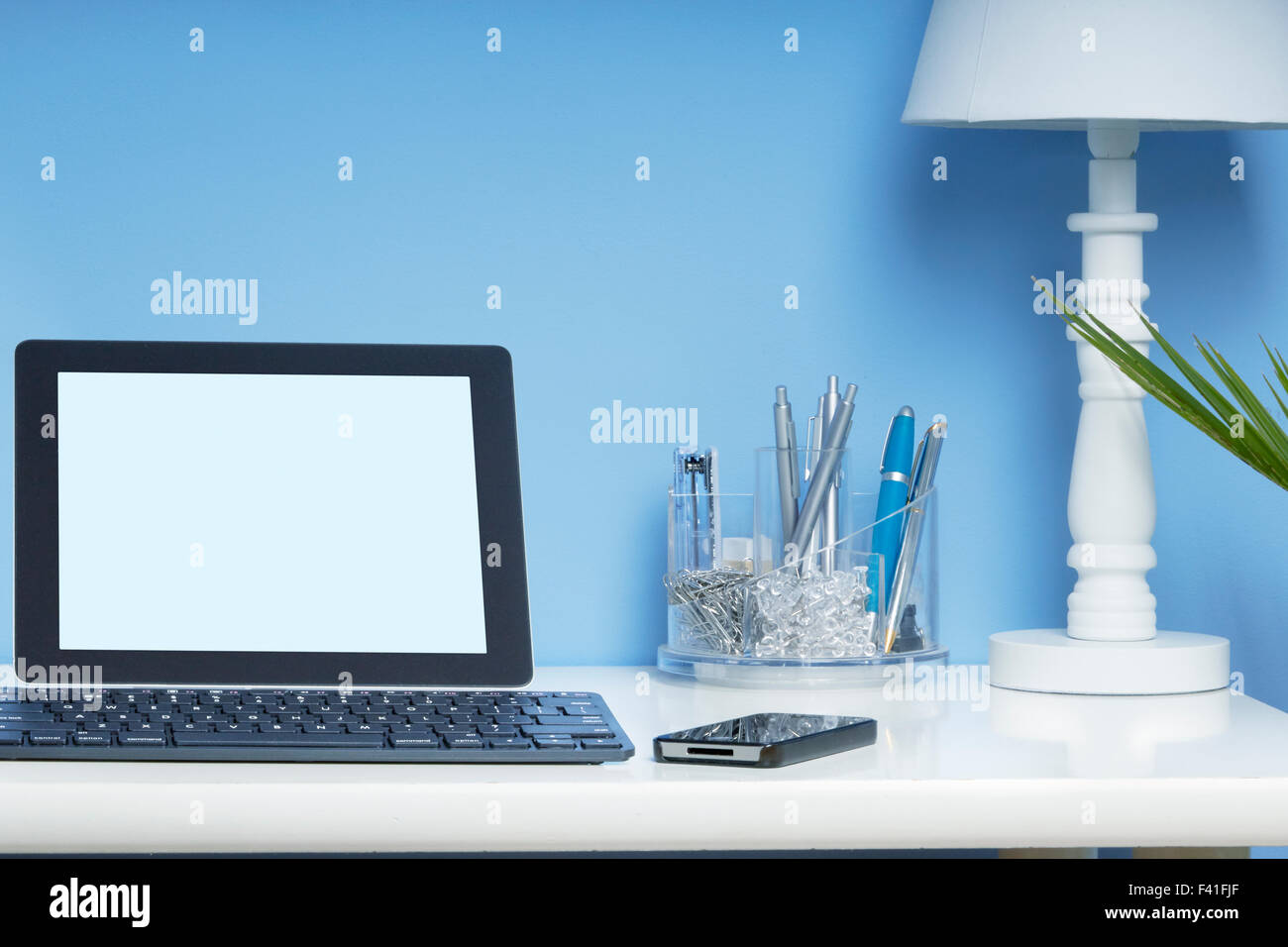 Home office interior set up with a blank Tablet screen to add copy ...