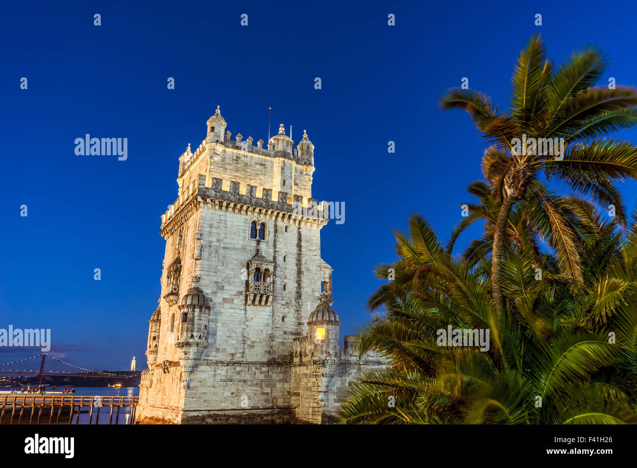 Right-side view of the Belem Tower with palms at dusk. Lisbon, Portugal ...