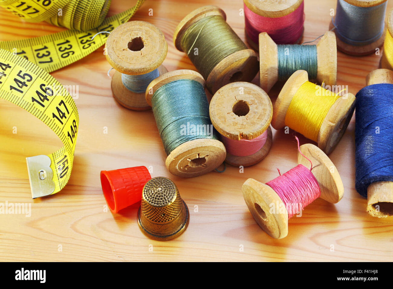 Reels of thread tapeline and two thimbles Stock Photo - Alamy
