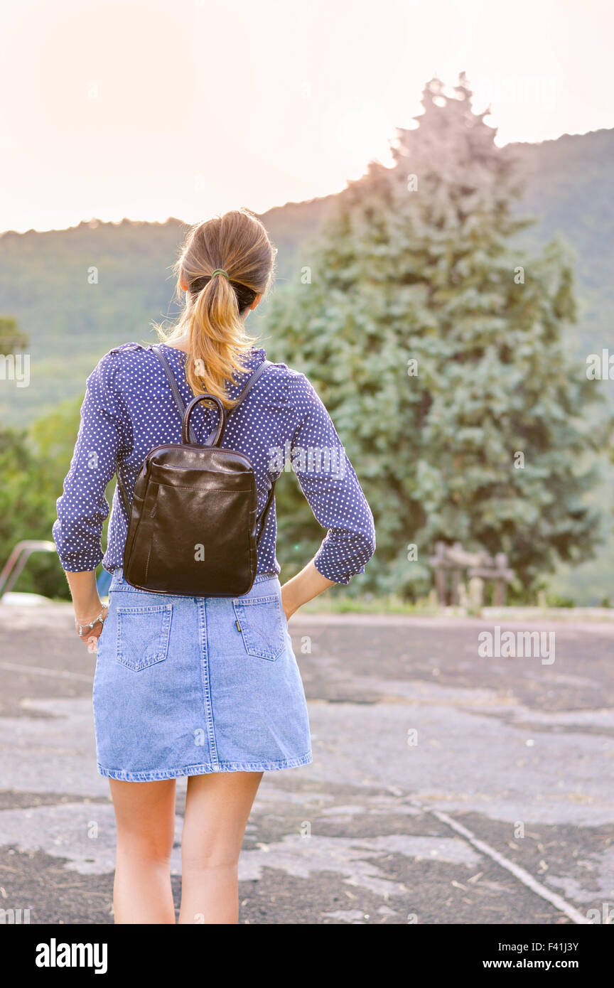 Back woman backpack looking sunset hi-res stock photography and images ...