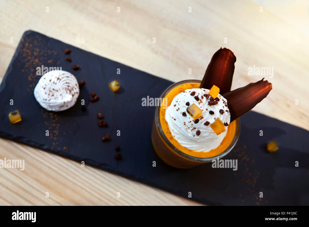 Mango cream, whipped cream and macaroon Stock Photo - Alamy