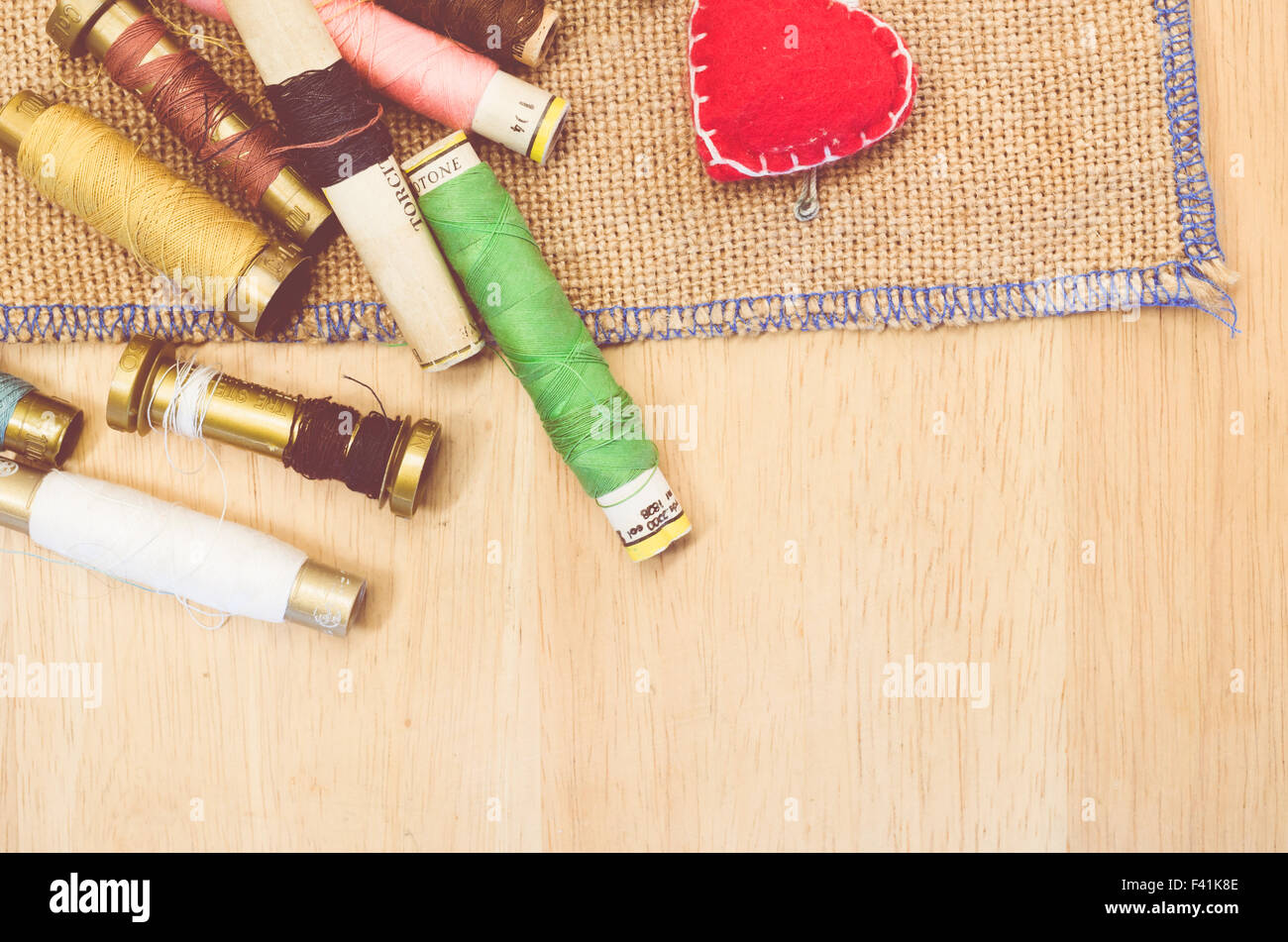 old sewing thread spools on burlap and wood background Stock Photo - Alamy