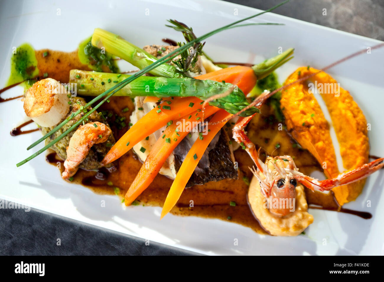 Dish with fish, crustacean, vegetable and sauce Stock Photo - Alamy