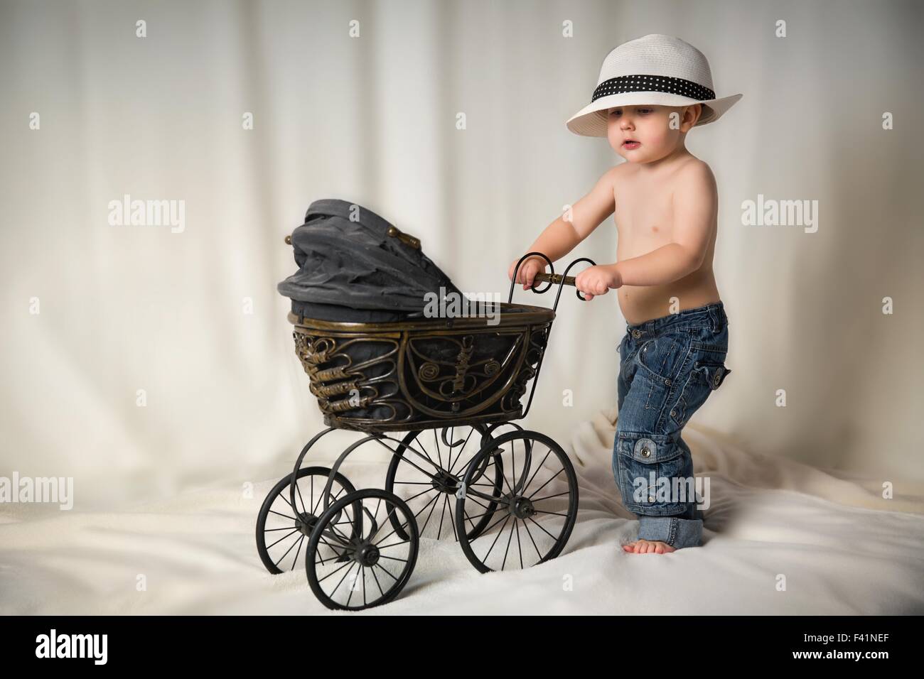 Little boy with antique stroller Stock Photo - Alamy