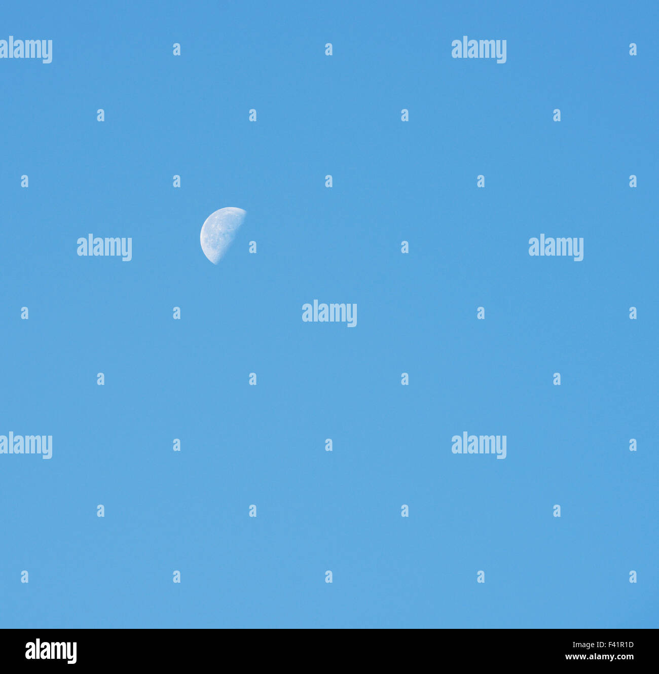 Half of Moon in blue sky background in early morning Stock Photo - Alamy
