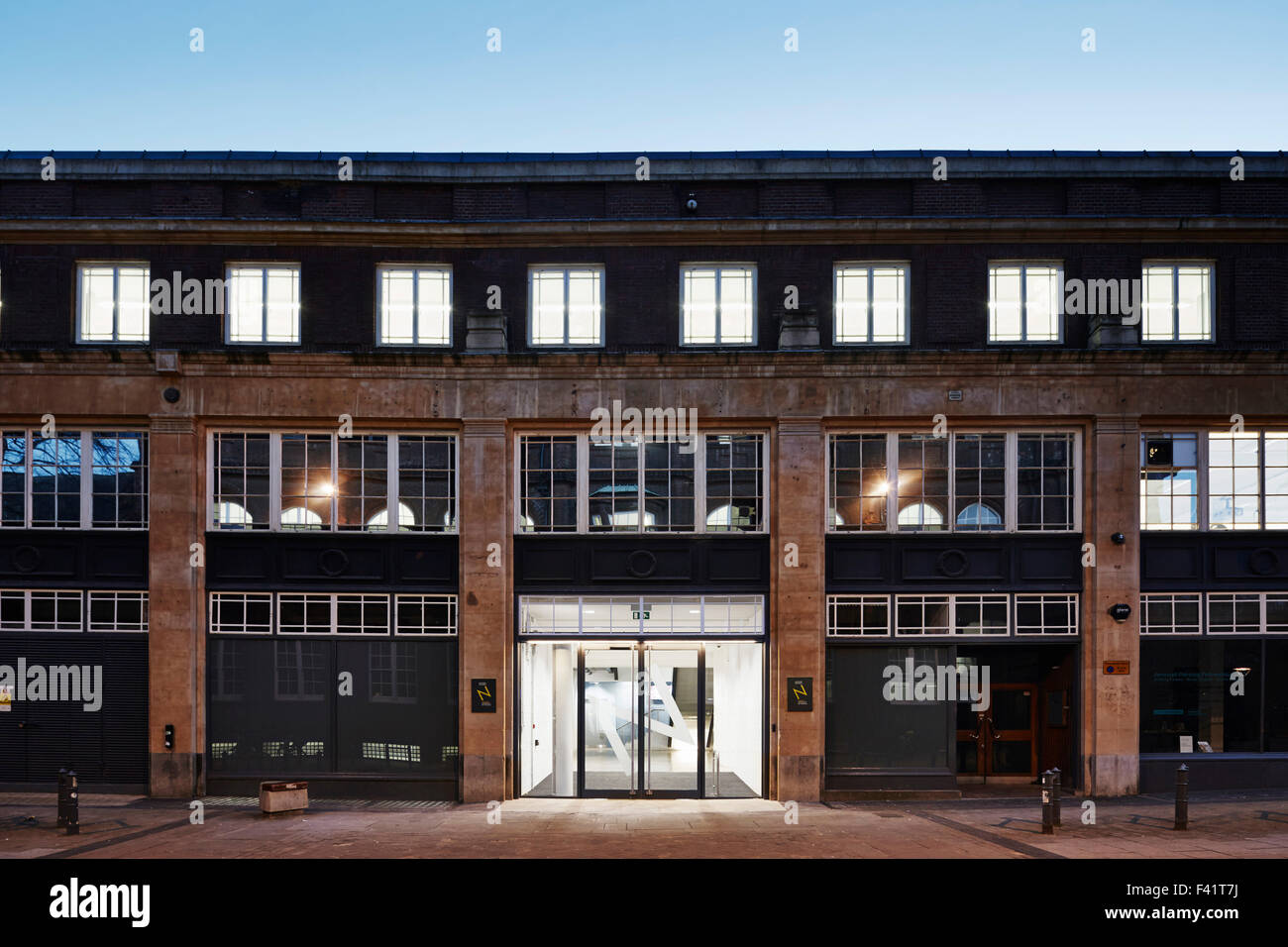 Front elevation of building entrance at dusk. Guntons Atrium - NUA ...