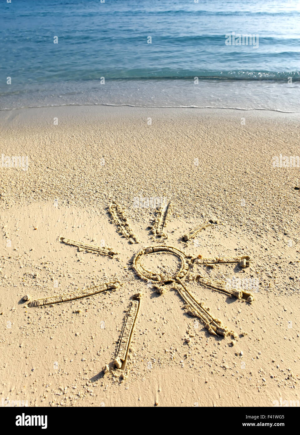 The sun - a picture on sand Stock Photo - Alamy