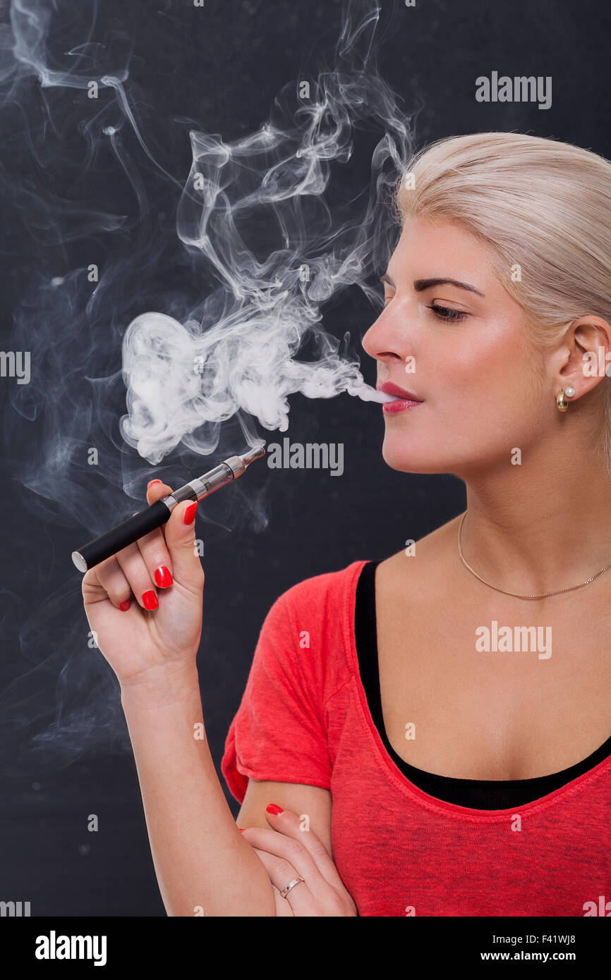 Young woman exhaling smoke hi-res stock photography and images - Alamy