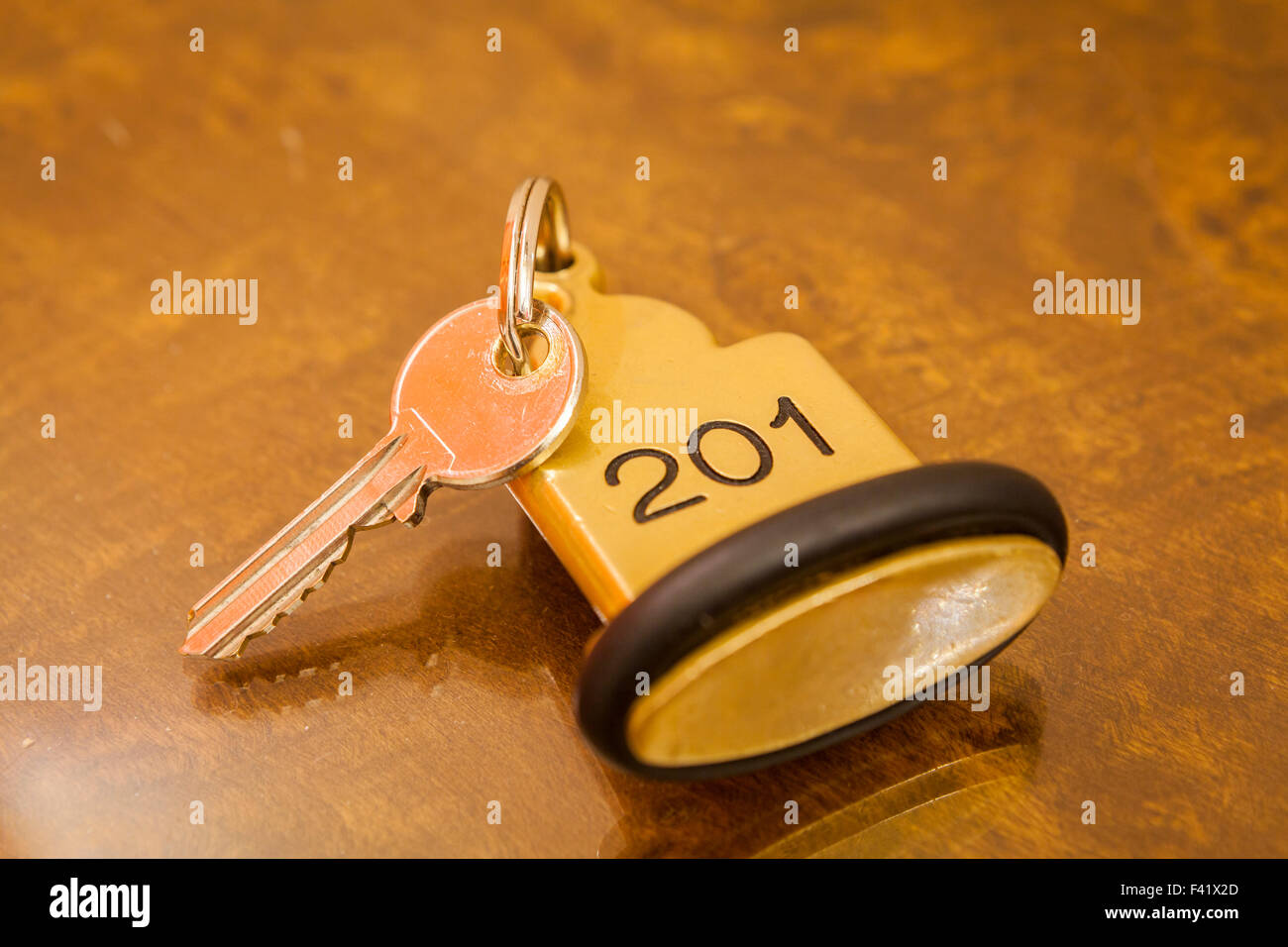 Hotel Room Key lying on Bed with keyring golden Stock Photo - Alamy