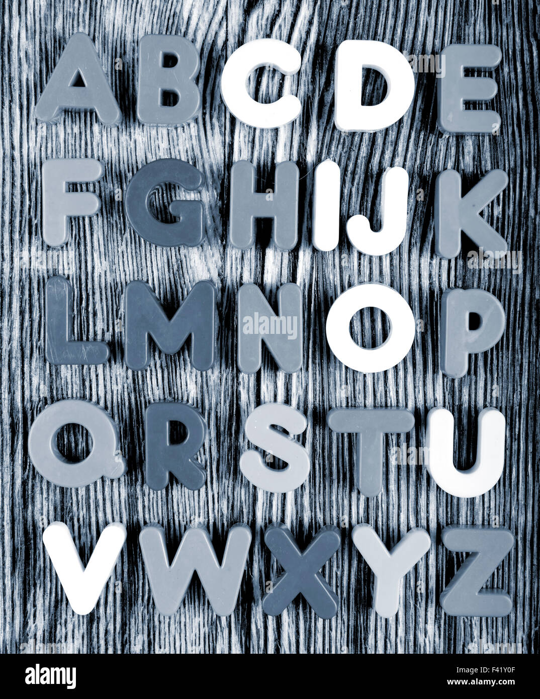 composition of colorful plastic alphabet letters on wooden background ...