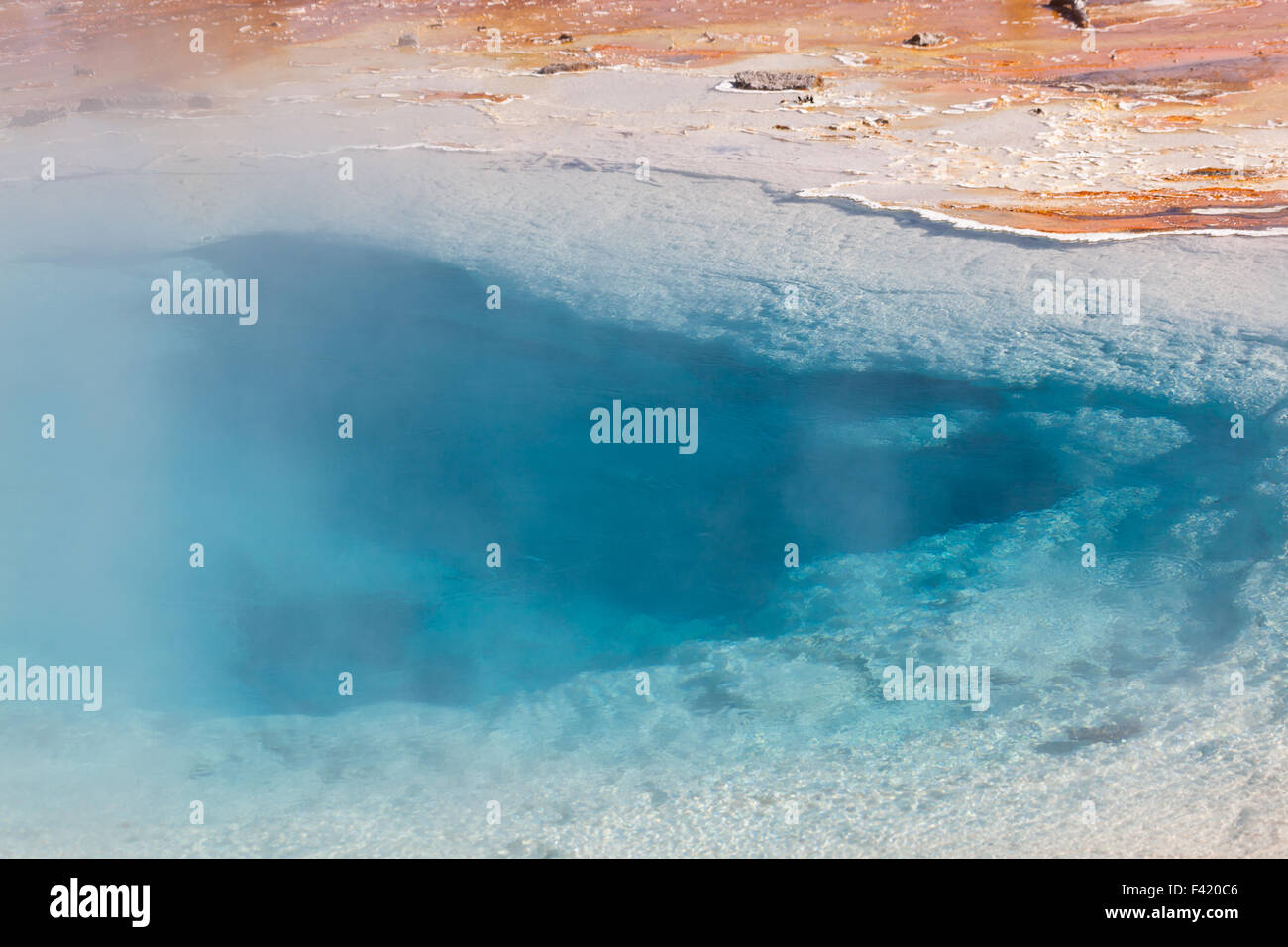 The hot steamy thermal water in Silex Spring pool reflecting the blue ...