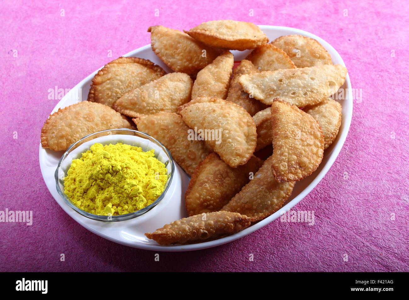 gujia in plate with holi color in bowl Stock Photo - Alamy