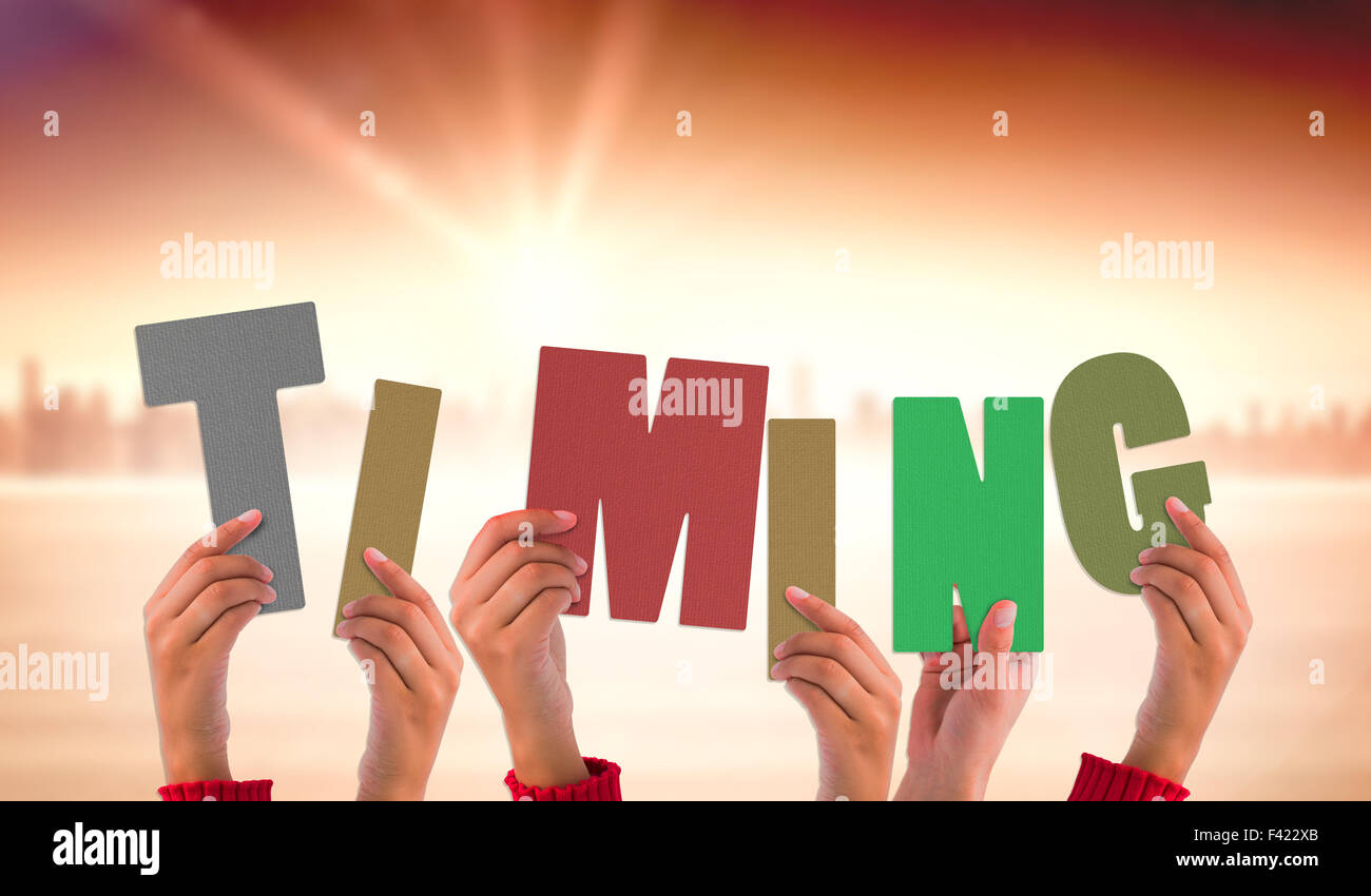 Composite image of hands showing timing Stock Photo - Alamy