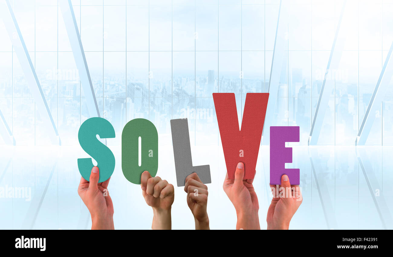 Composite image of hands holding up solve Stock Photo - Alamy