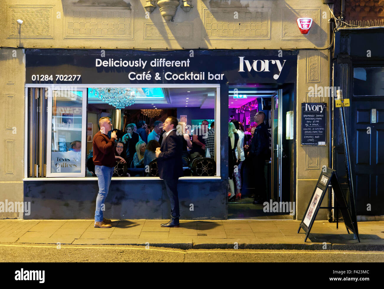 exterior of café bar at night Stock Photo - Alamy
