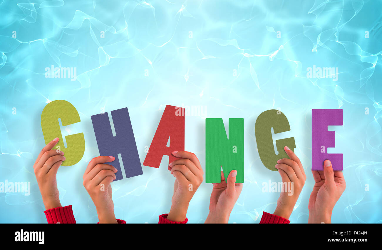 Composite image of hands holding up change Stock Photo - Alamy