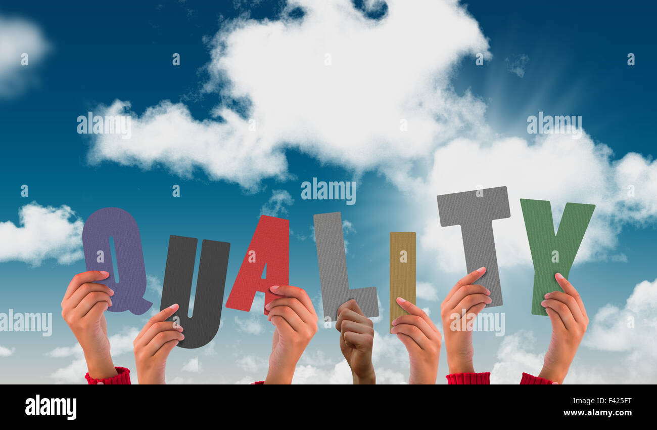 Composite image of hands holding up quality Stock Photo - Alamy